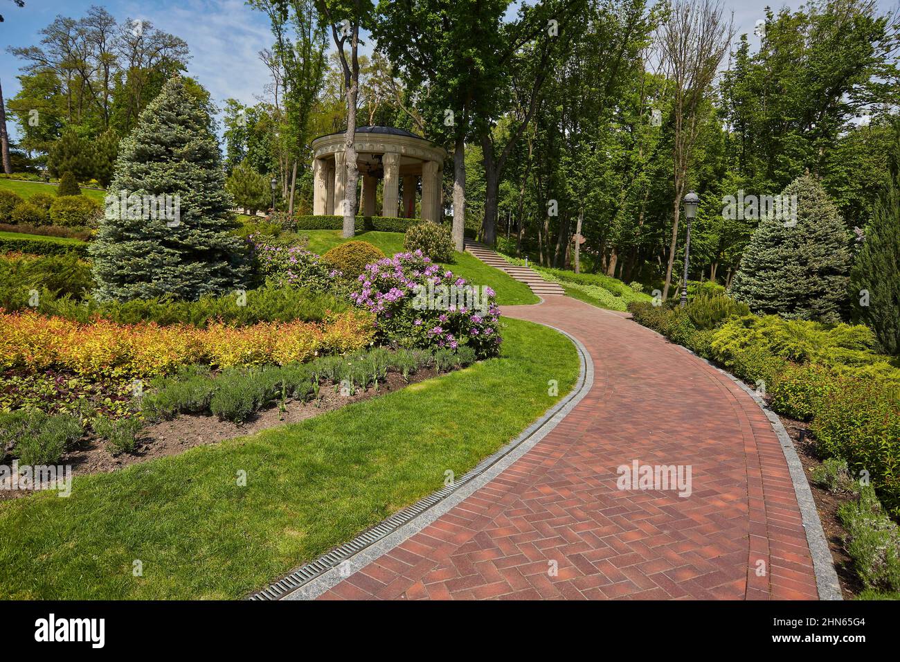 Beautiful summer garden with a walkway winding its way through Stock ...