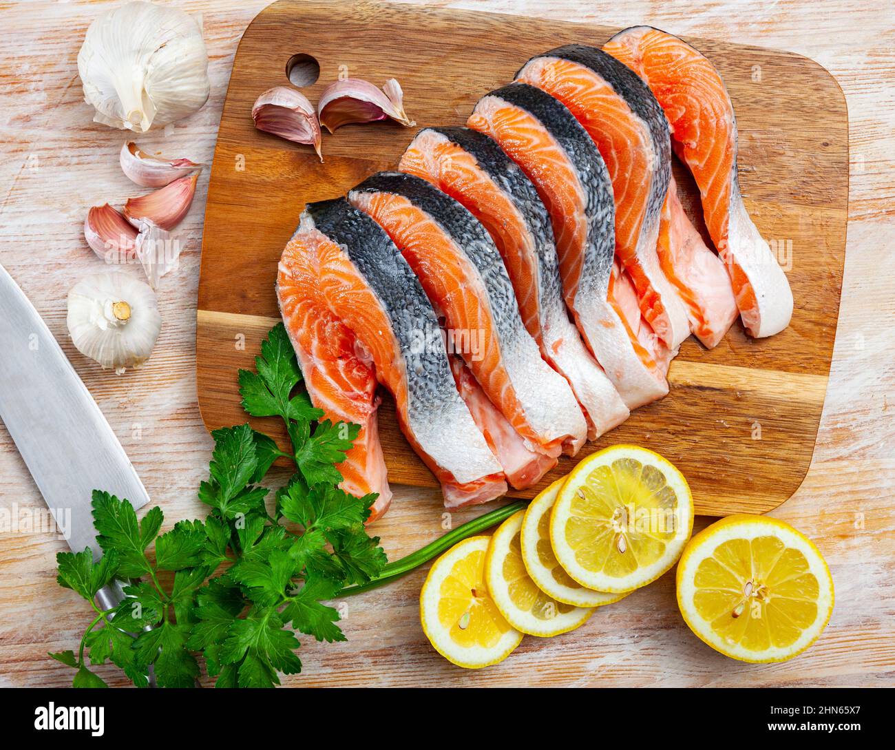 Image of raw salmon steaks with lemon and greens Stock Photo - Alamy