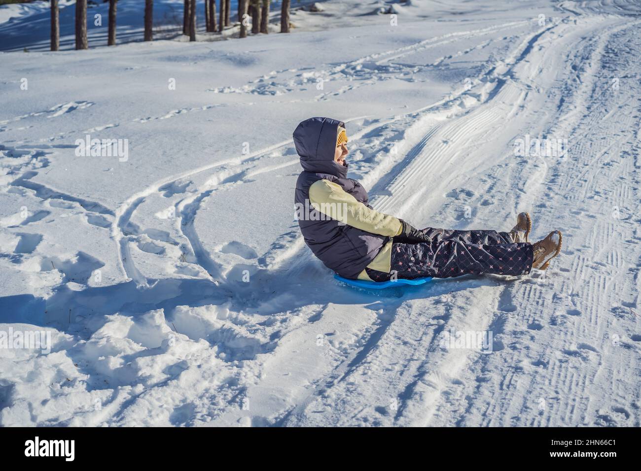 Happy mature woman sledding downhill hi-res stock photography and ...
