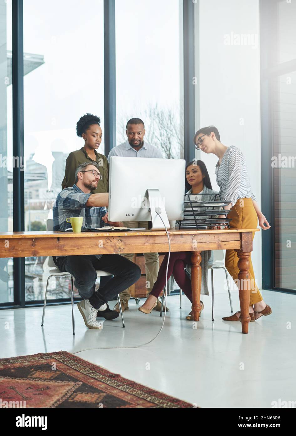 Working together to get the task done. Shot of businesspeople working ...