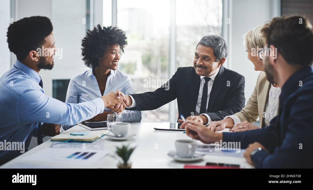 Welcome to the team. Cropped shot of a diverse group of businesspeople ...