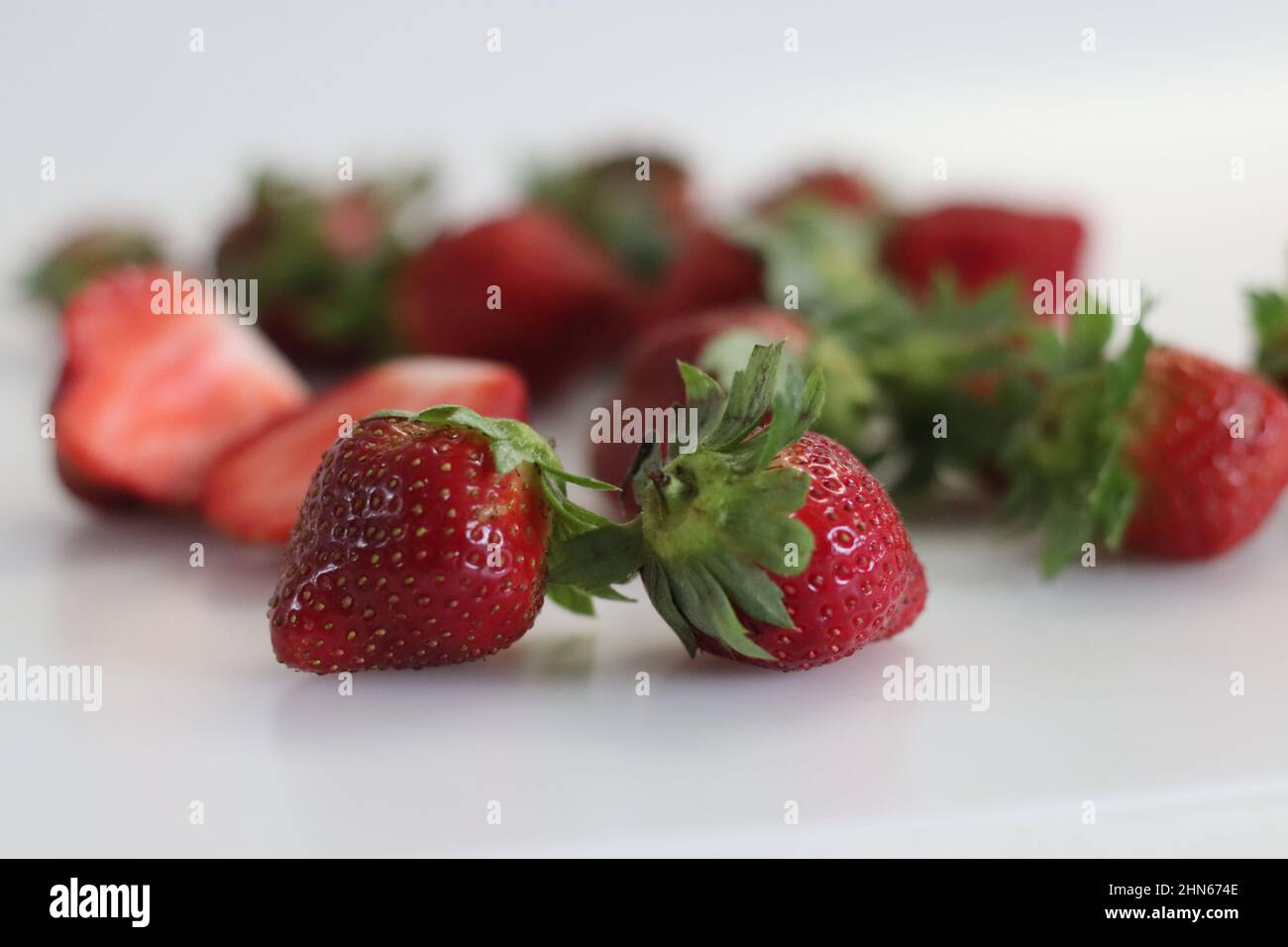 Fresh strawberries. Small and big. Pink red and green combination. Shot ...