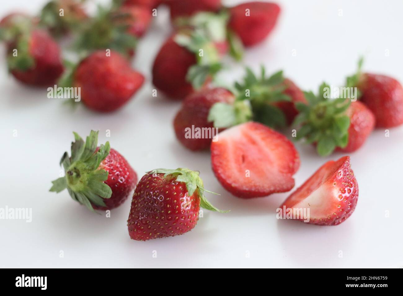 Fresh strawberries. Small and big. Pink red and green combination. Shot ...