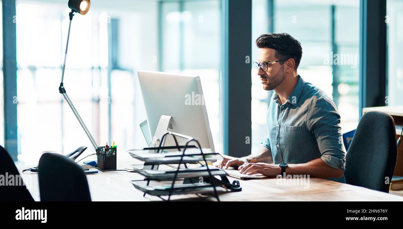 The successful stay consistent. Shot of a focused young businessman ...