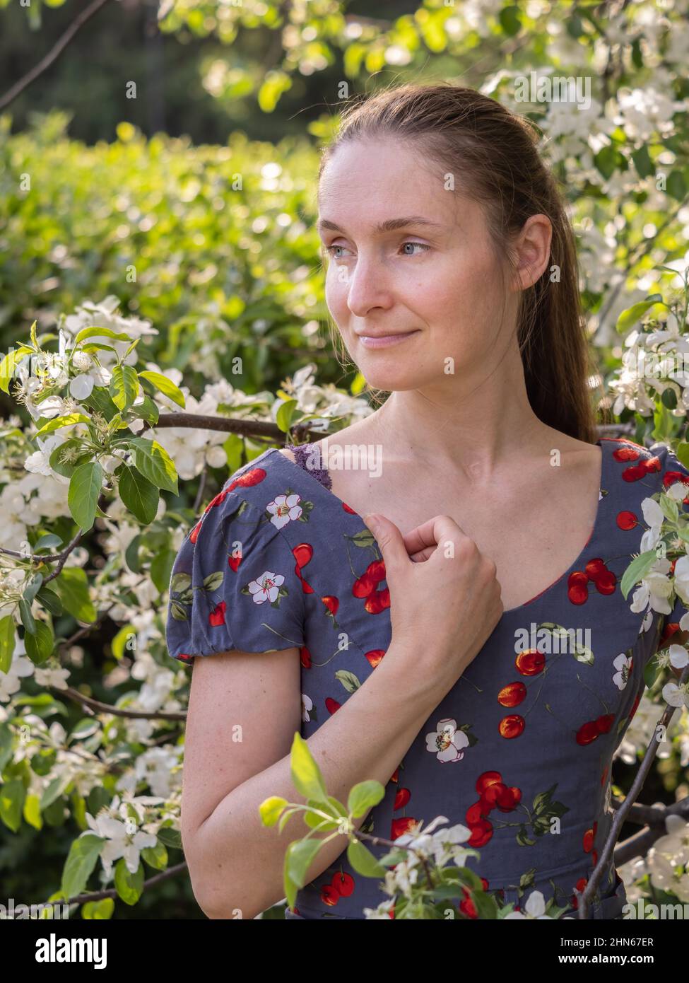 Beautiful Young Woman Without Makeup In A Spring Park Among Flowering