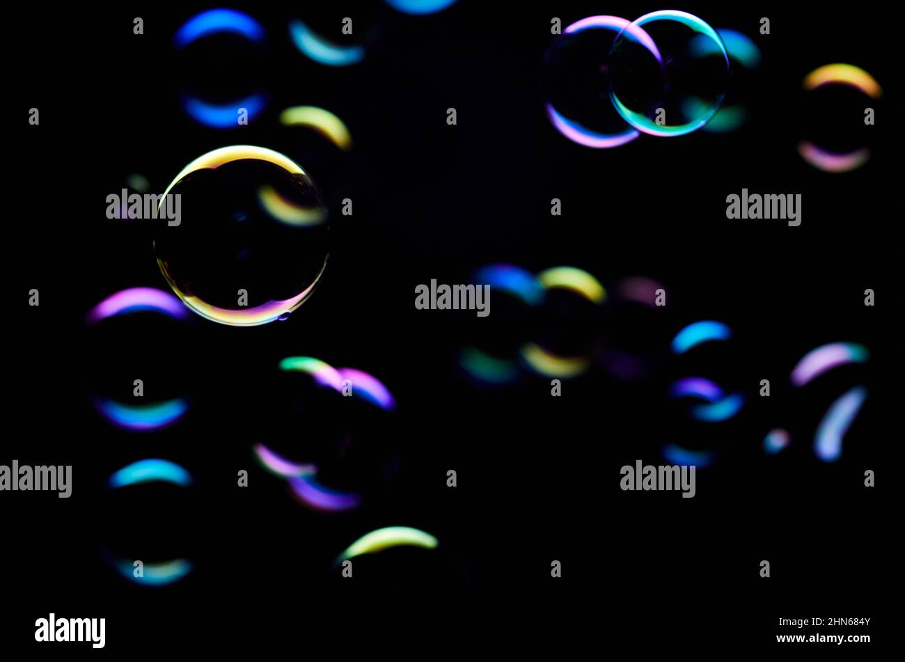 The colorful light reflection on the bubbles in the dark Stock Photo ...