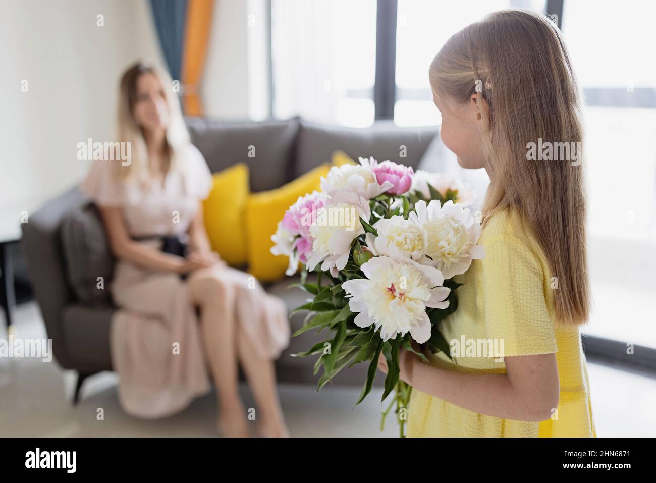 Child daughter congratulates mother and gives present card, gift and ...