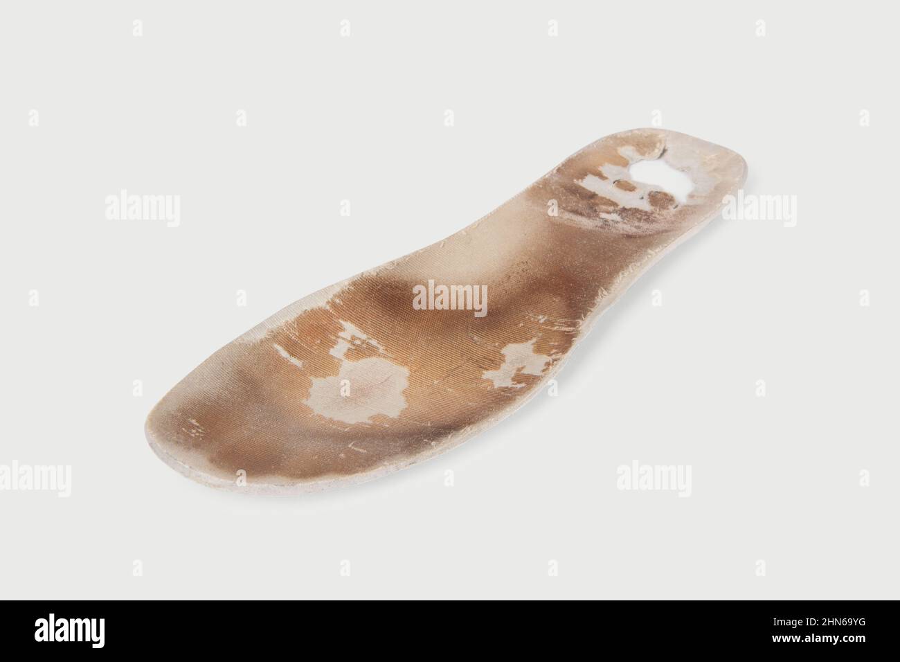 Old and shabby orthopedic insoles isolated on white background. Dirty ...