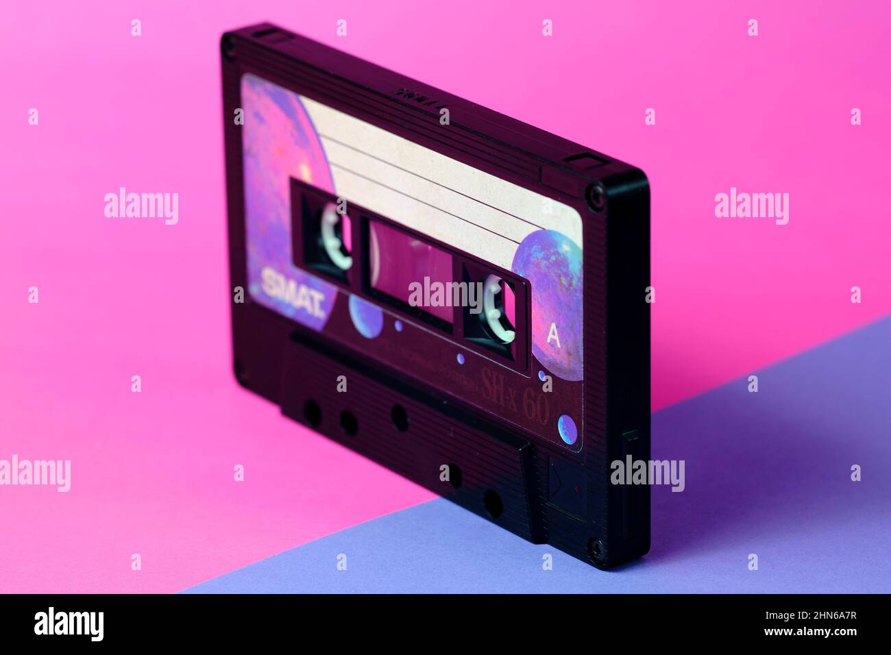 Vintage audio cassette isolated in perspective. Pink and purple ...