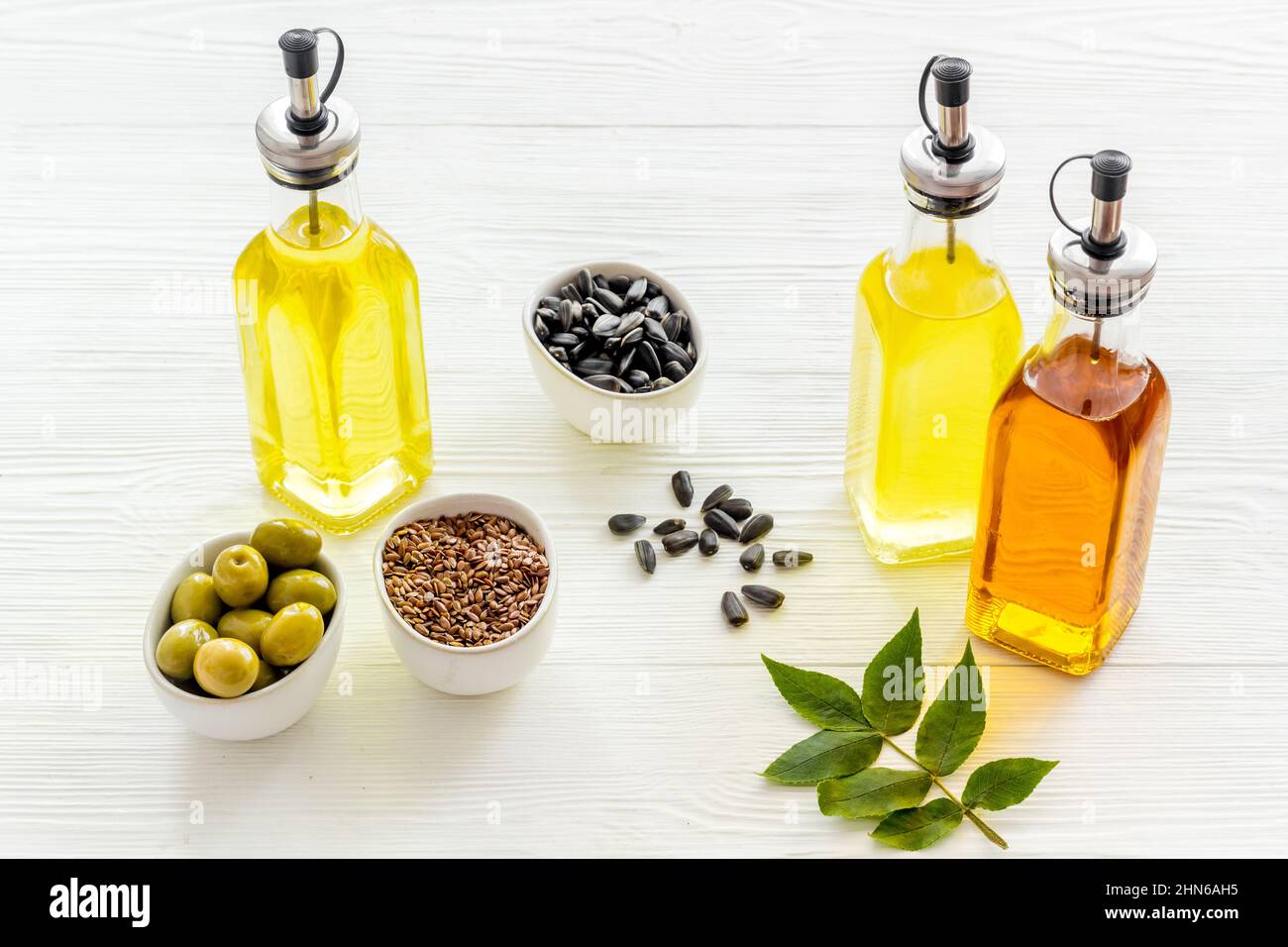 Bottles of vegetarian cooking oil - sunflower olive and sesame oil with ...