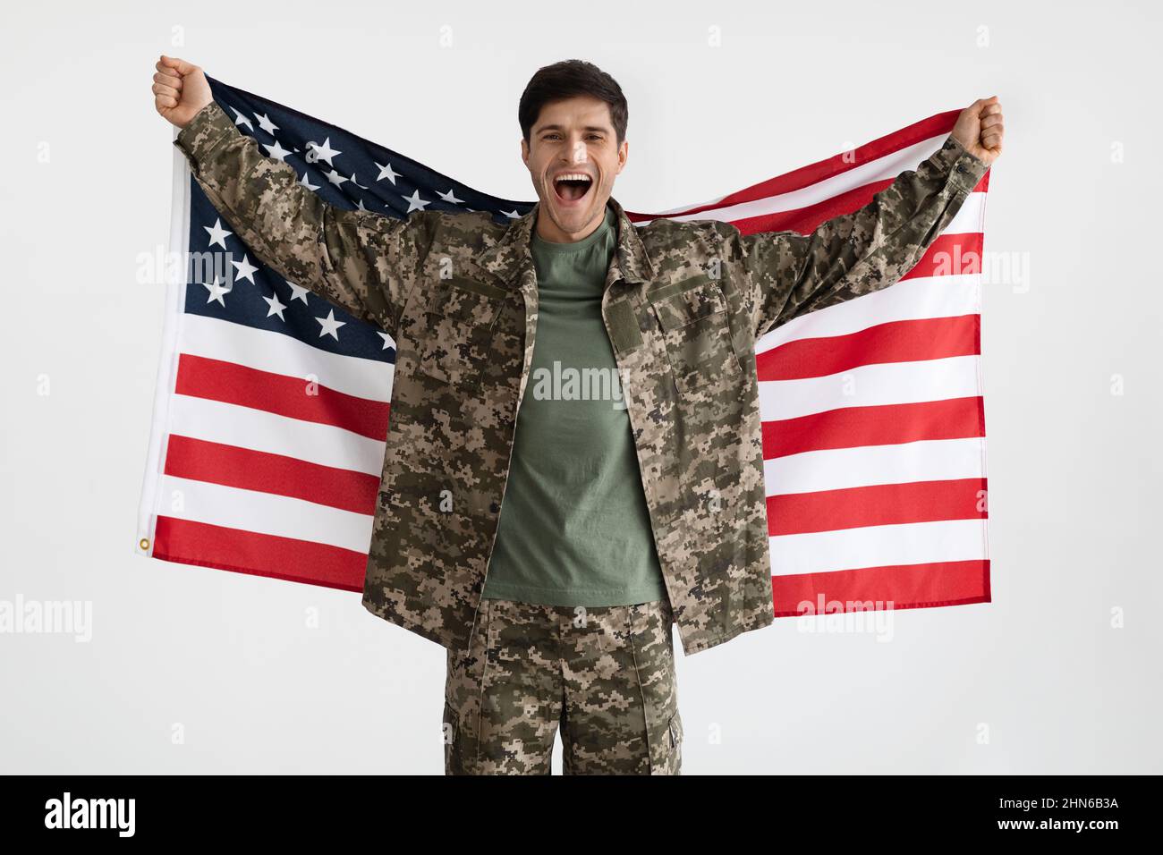Cheerful military guy with flag of the US on white Stock Photo - Alamy