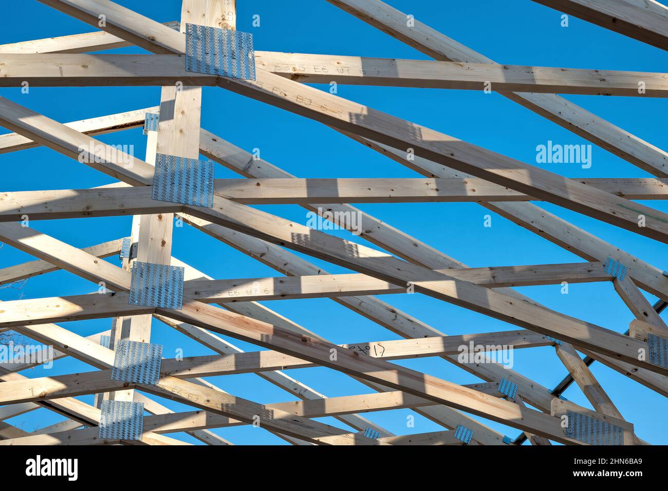 Roof trusses on a new home construction project with blue sky Stock ...