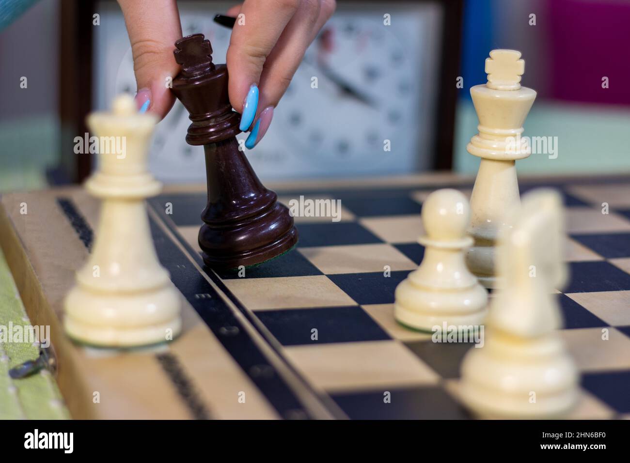 Hand of girl makeing a movement with a chess piece Stock Photo - Alamy