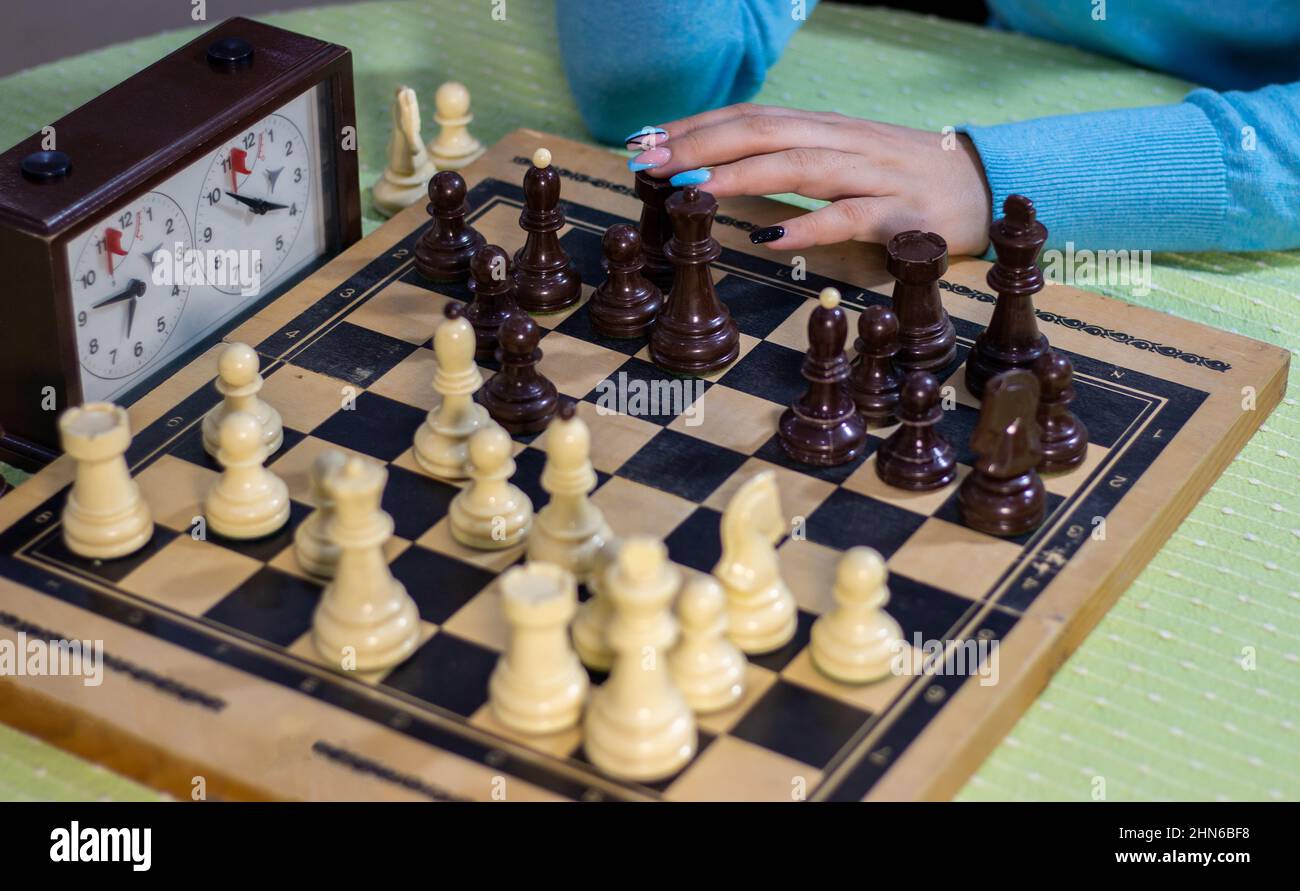 Hand of girl makeing a movement with a chess piece Stock Photo - Alamy