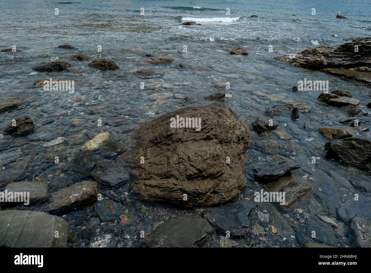 rocks of different sizes in the sea across the waves. top view. Natural ...