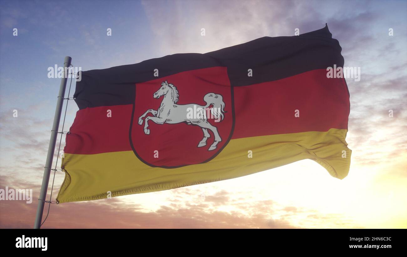 Lower Saxony flag, Germany, waving in the wind, sky and sun background ...