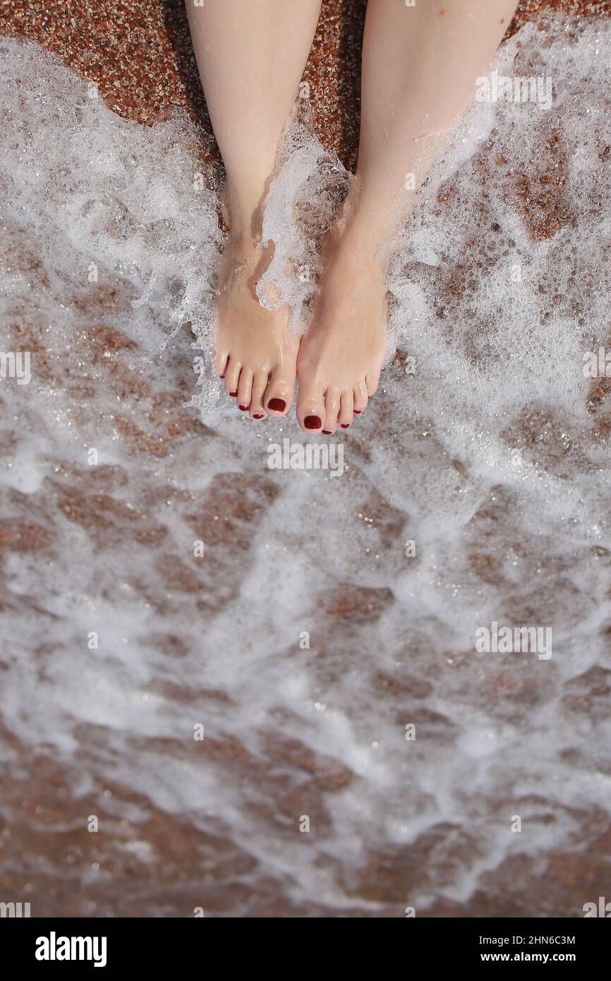 Travel Concept Womans Legs On Beautiful Tropical Beach With Pebble