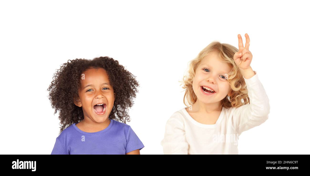 Two children doing hand gestures and laughing isolated on a white ...