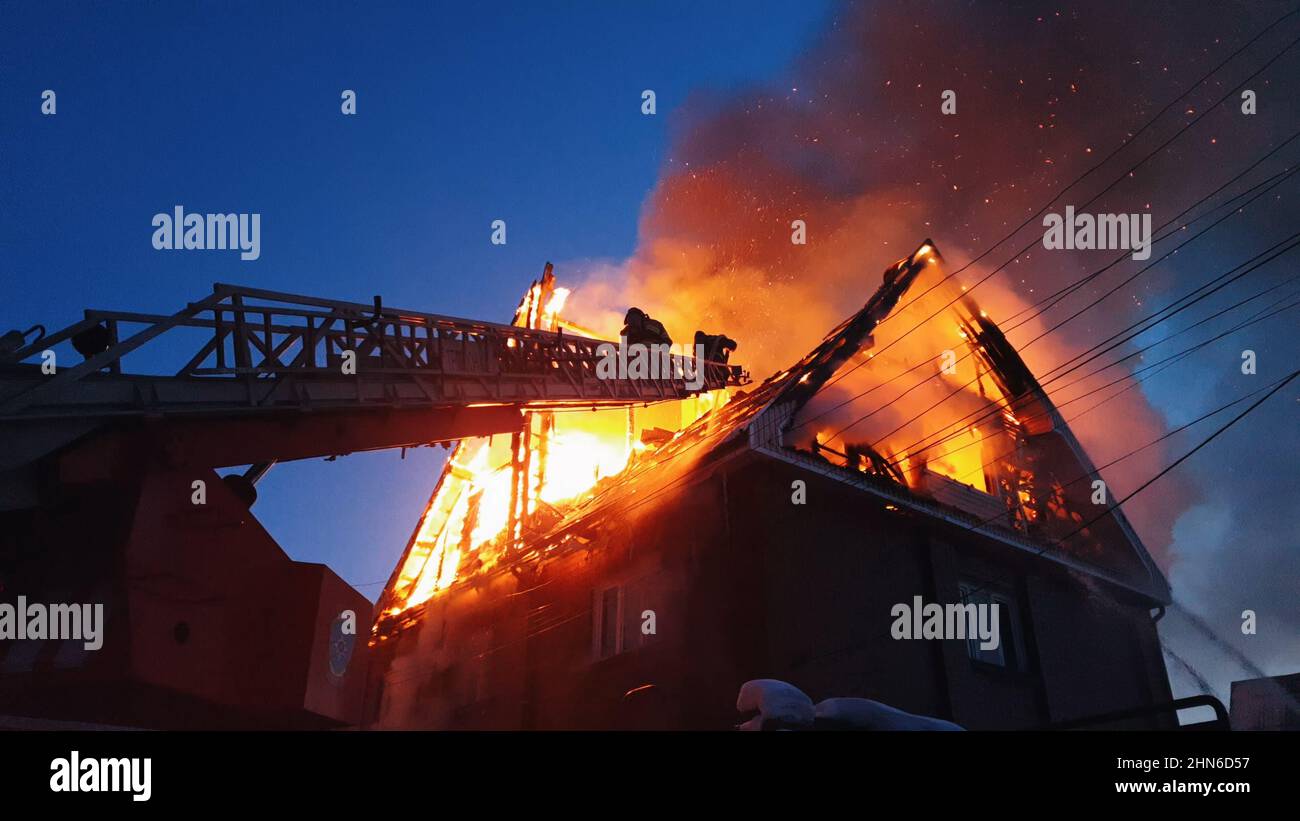 The roof of the house is on fire. The residential building burn ...