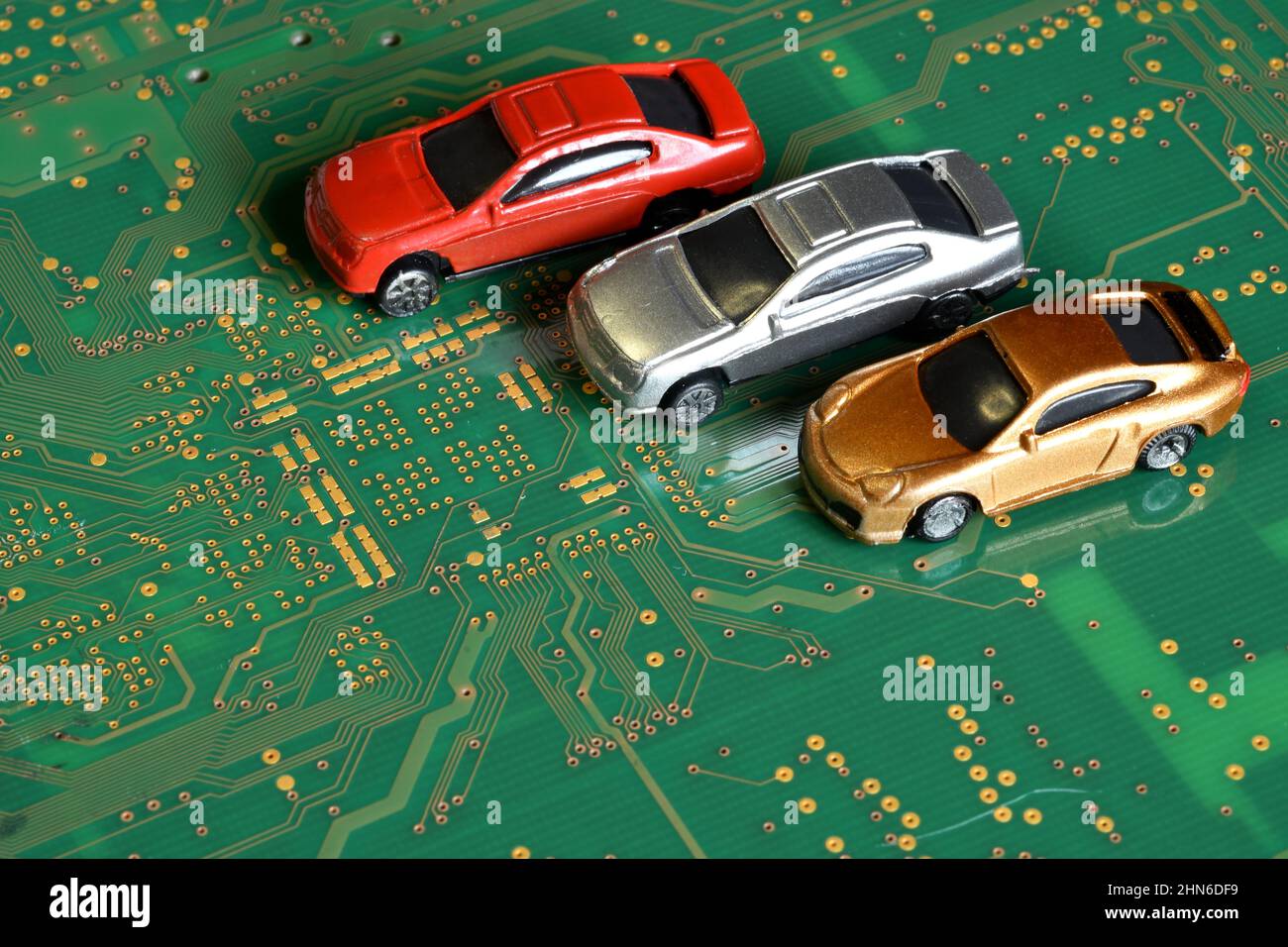 Toy cars on an electronic board with integrated circuits. The shortage ...