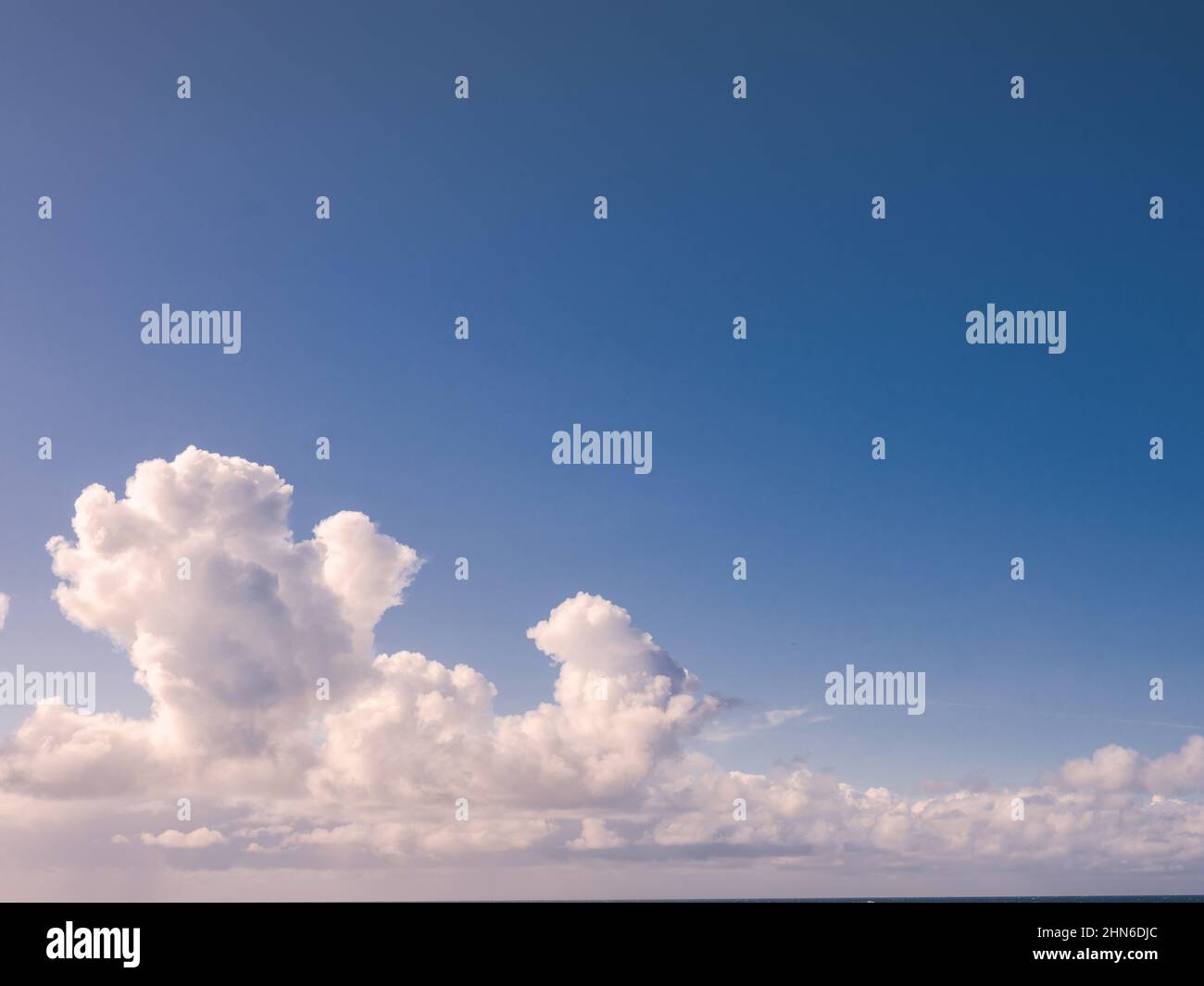 Fluffy white clouds and blue sky Stock Photo - Alamy