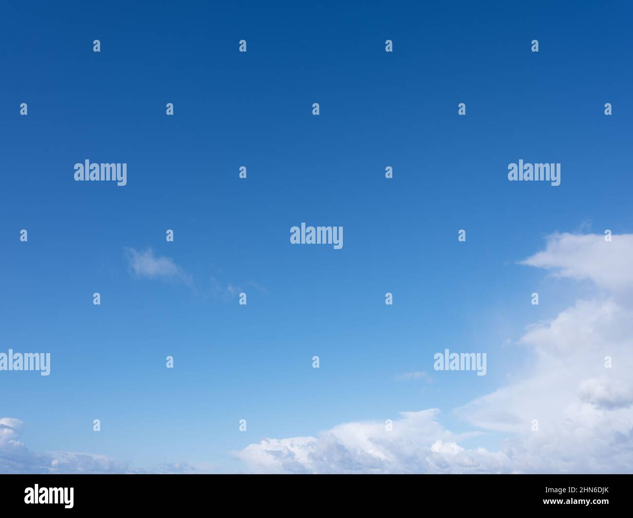 Fluffy white clouds and blue sky Stock Photo - Alamy
