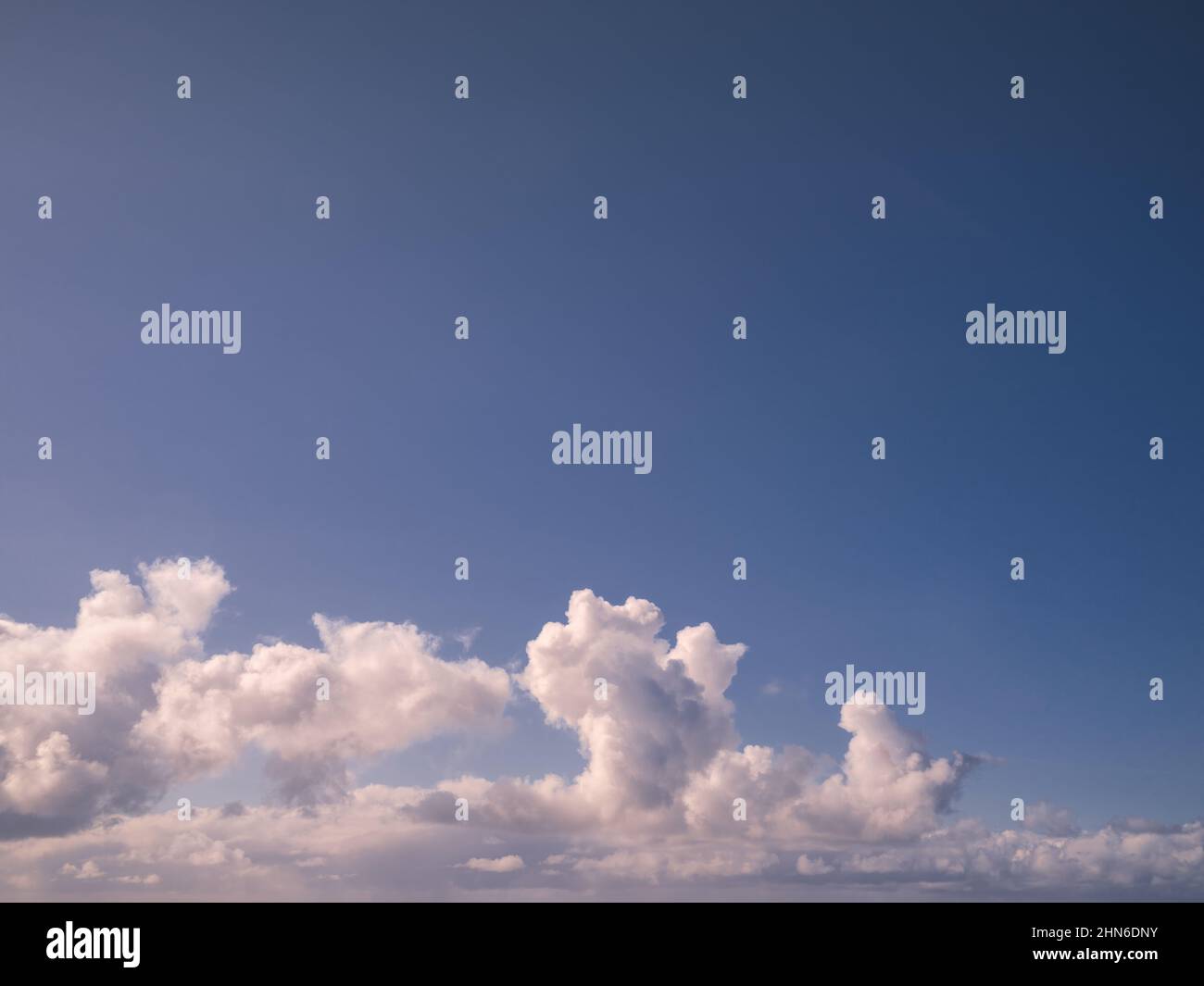 Fluffy white clouds and blue sky Stock Photo - Alamy