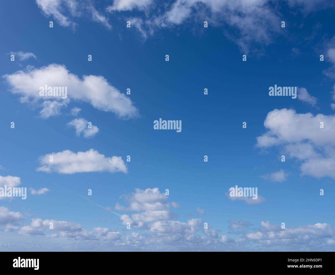 Fluffy white clouds and blue sky Stock Photo - Alamy
