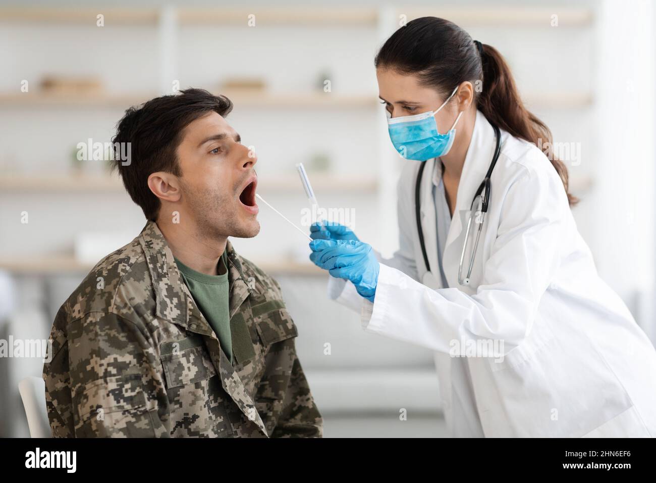 Doctor taking sample for DNA test from soldier in clinic Stock Photo ...