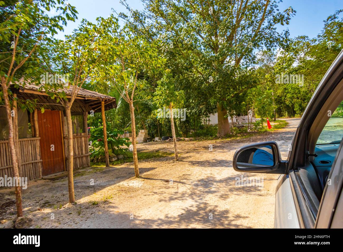 Driving on the gravel path road in the jungle and tropical nature of ...