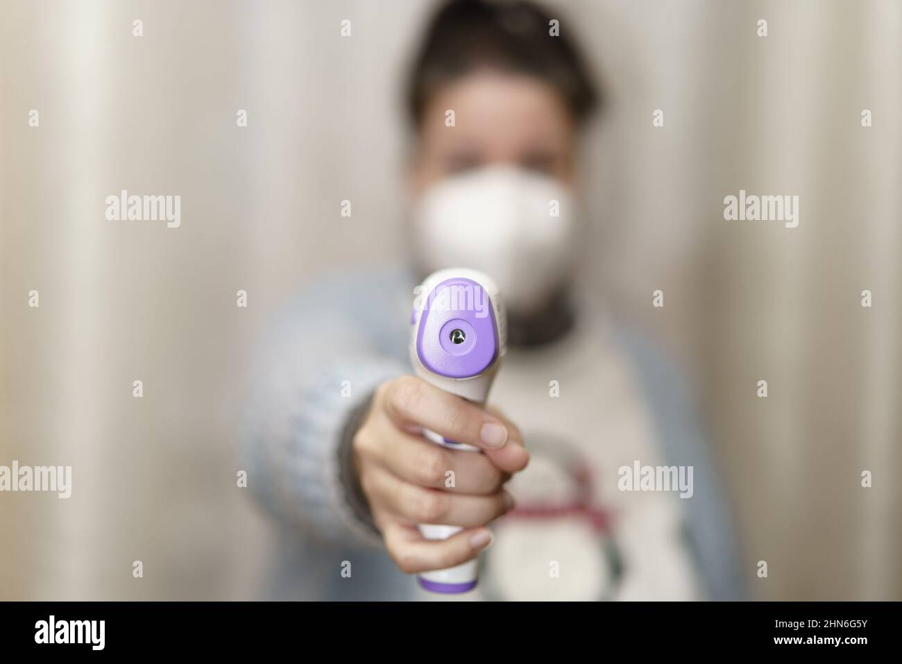Woman taking temperature with a digital thermometer Stock Photo - Alamy