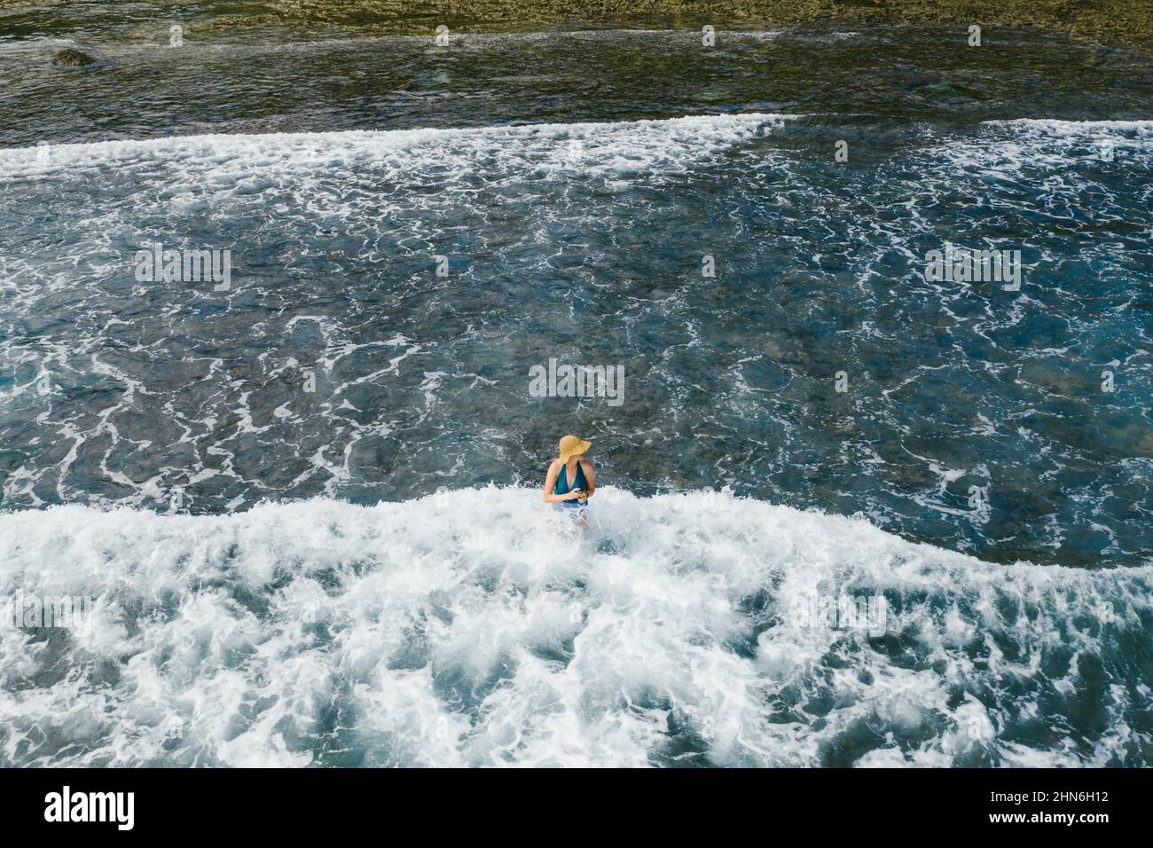 Woman in blue waves of the ocean from a drone Stock Photo - Alamy
