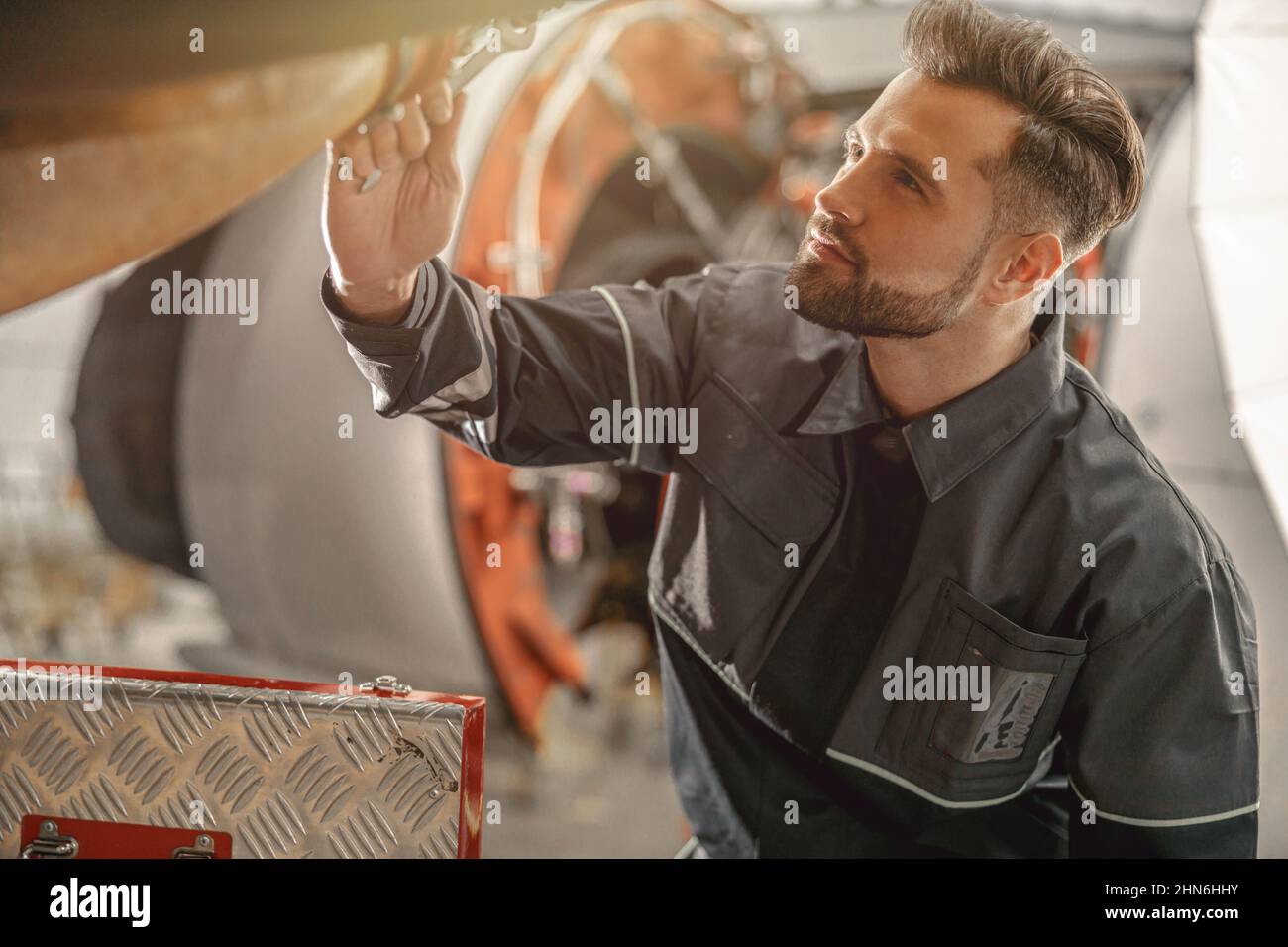 Male aviation mechanic repairing aircraft in hangar Stock Photo - Alamy