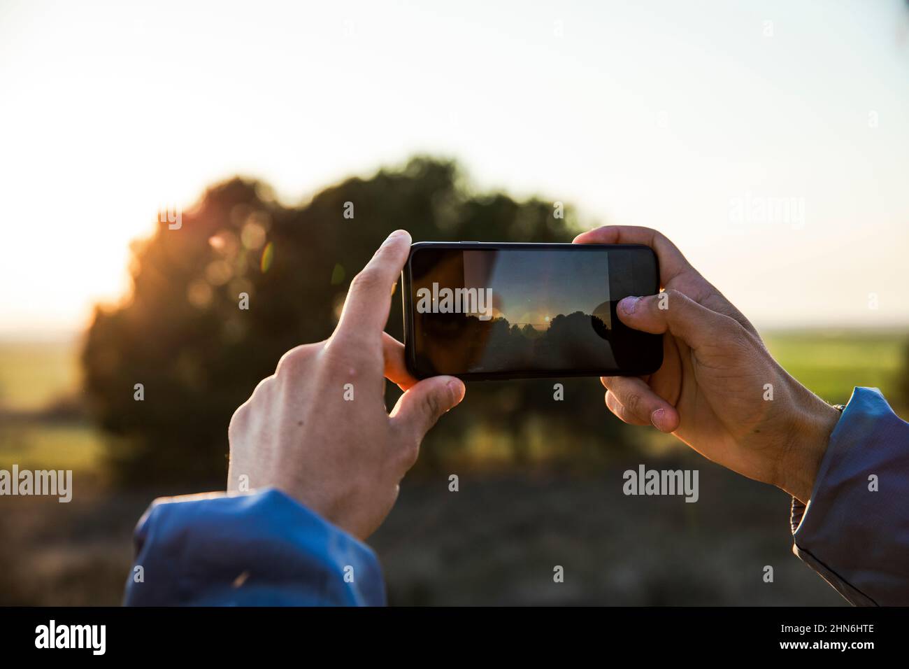 Hands of a young boy taking a photo with a smartphone Stock Photo - Alamy