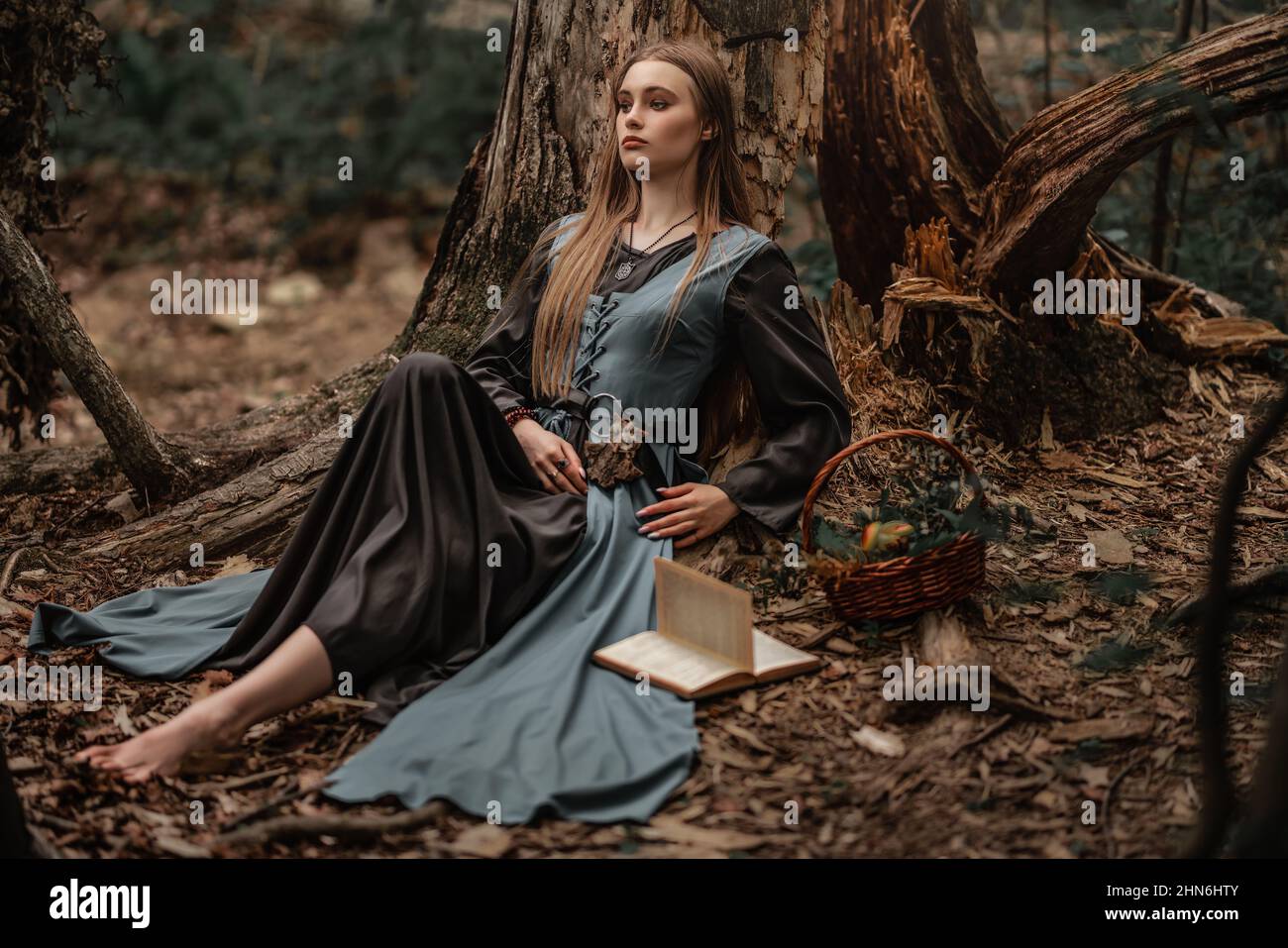 A mysterious witch walks in a dark forest Stock Photo - Alamy