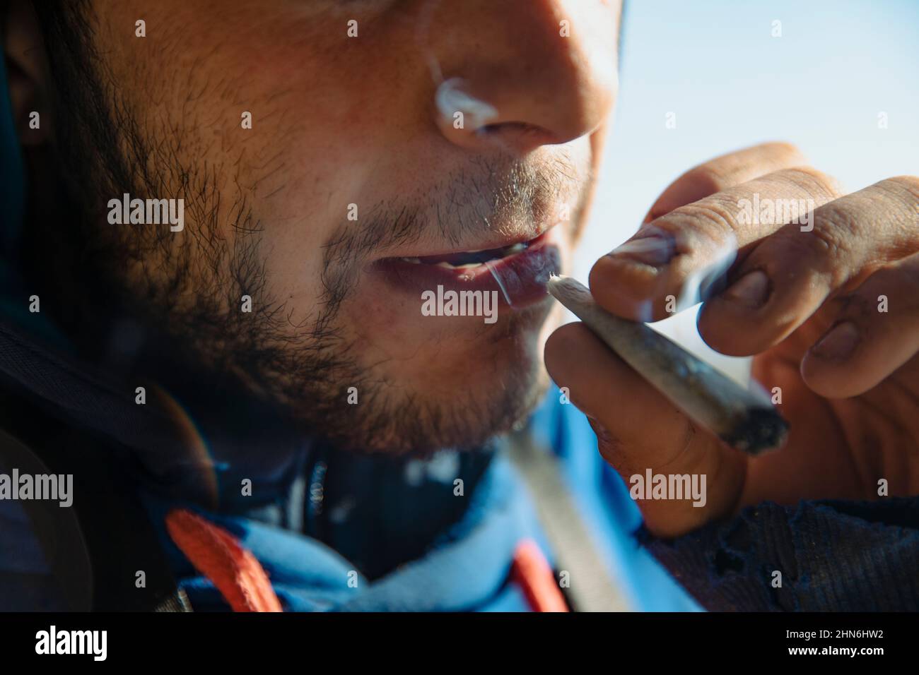 Close-up of young man smoking a marijuana joint outdoors Stock Photo ...