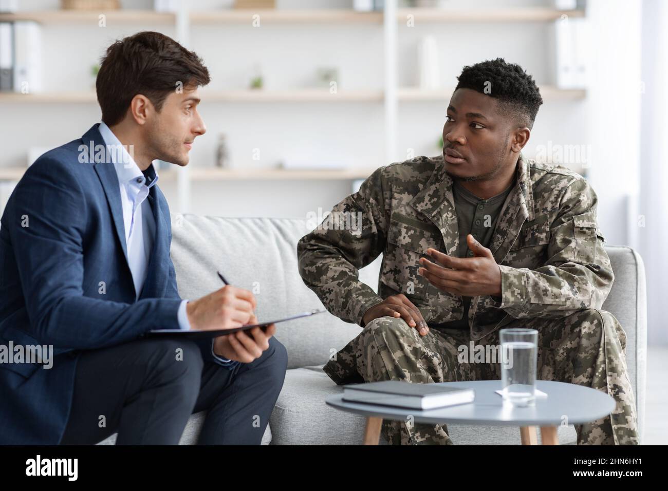 African american military man attending therapy session with ...