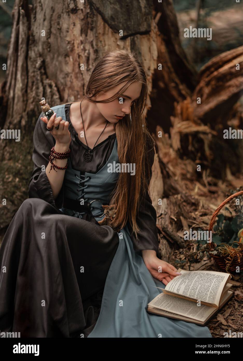 A mysterious witch walks in a dark forest Stock Photo - Alamy