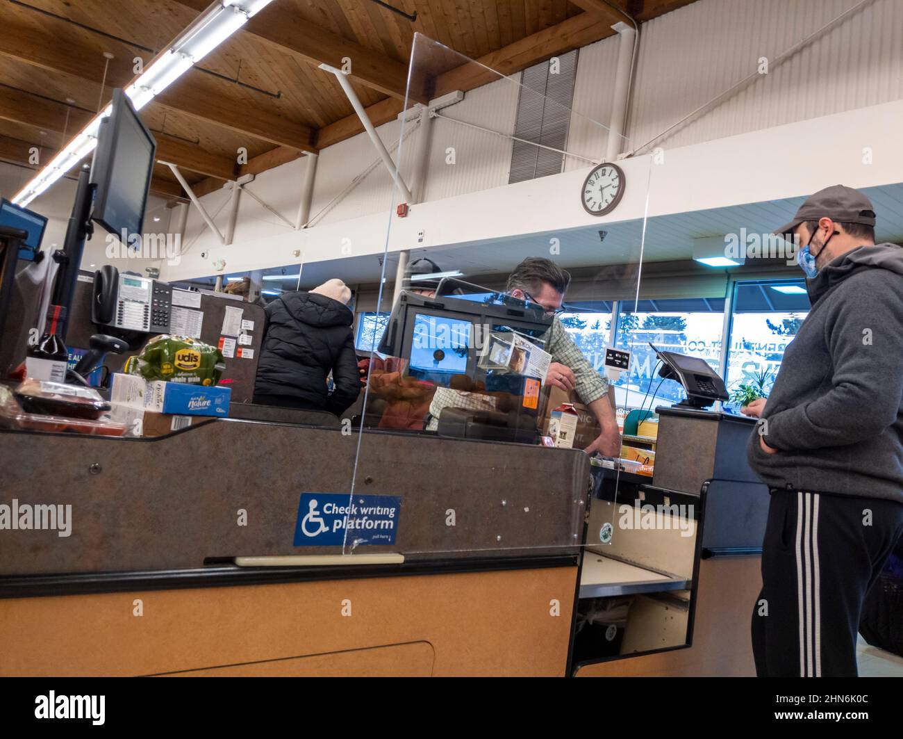 Kirkland, WA USA - circa December 2021: View of a male cashier behind a ...