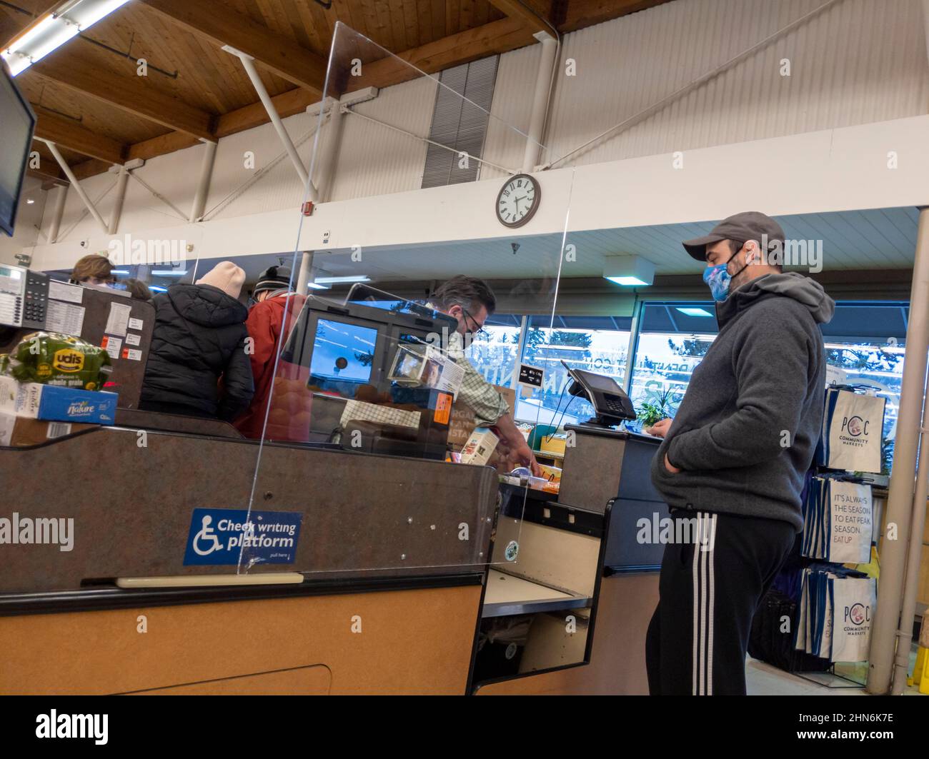 Kirkland, WA USA - circa December 2021: View of a male cashier behind a ...