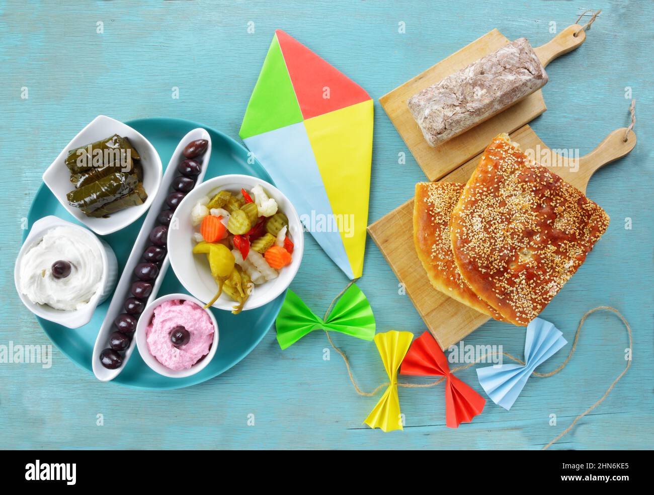 Colorful kite and fasting food for Clean Monday on turquoise table ...