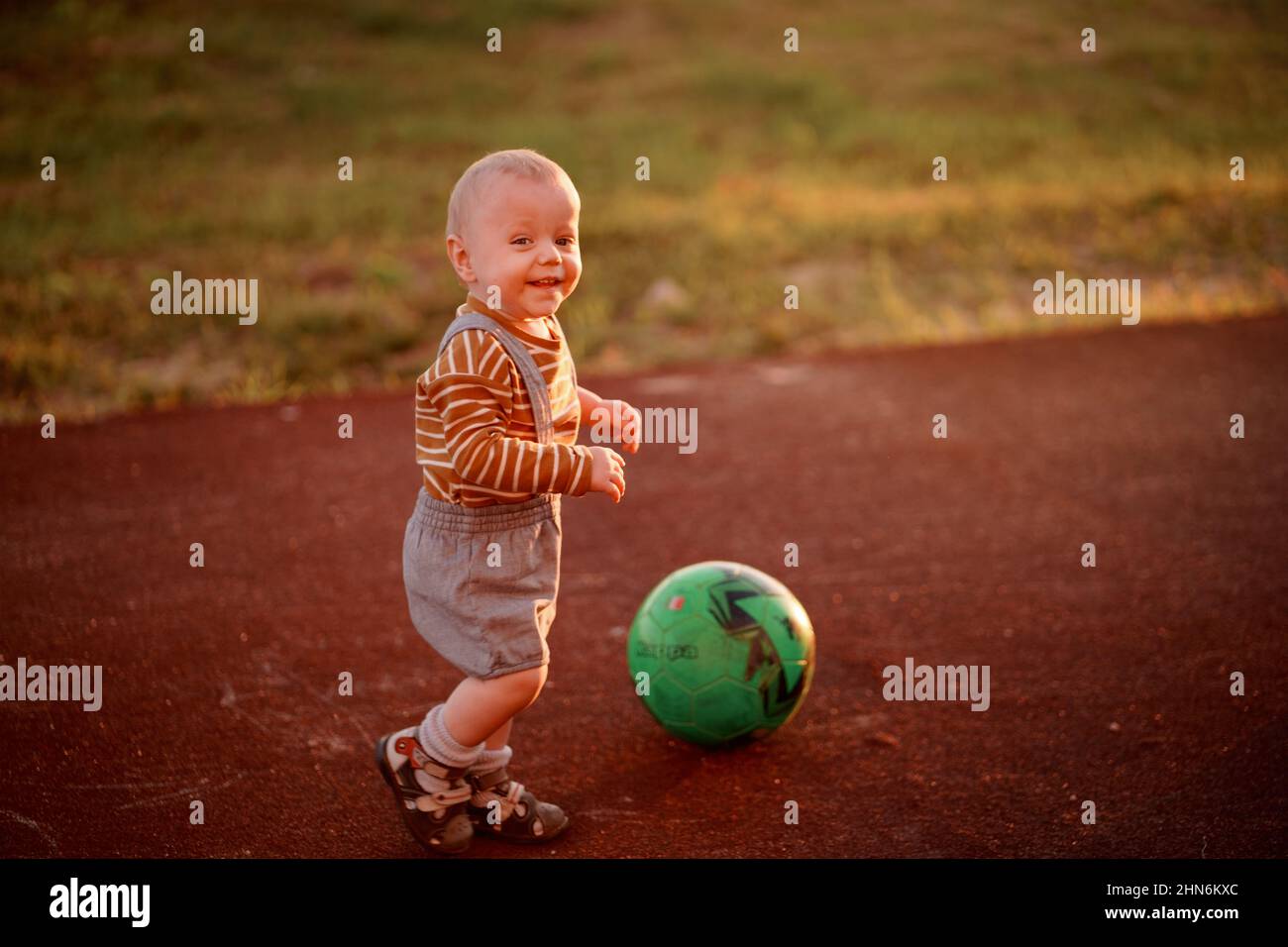 child playing ball on the playground Stock Photo - Alamy