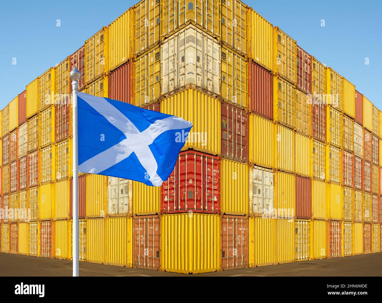 Flag of Scotland with stacked shipping containers in background ...