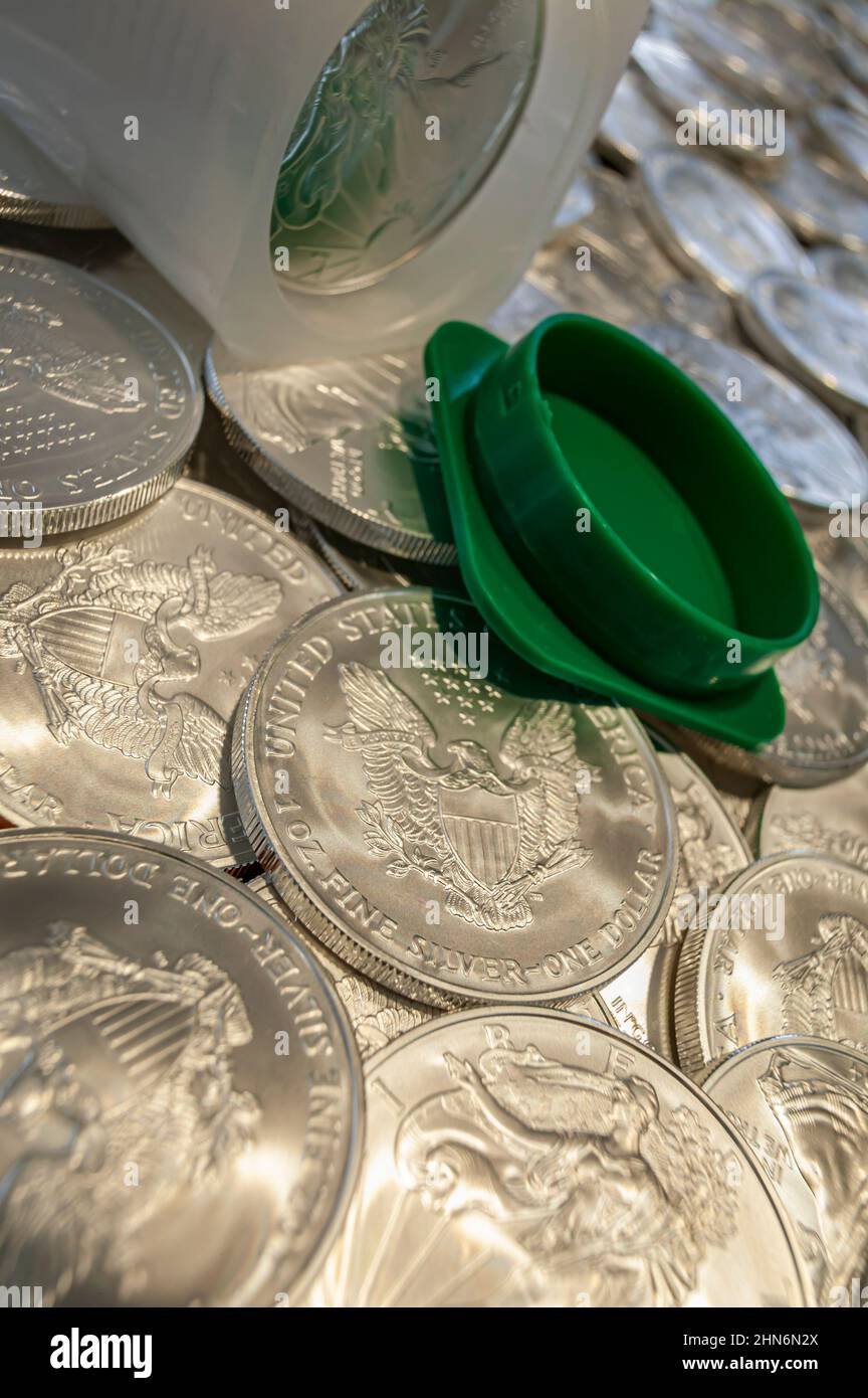 A tight, detail shot of Liberty Silver bullion with an empty coin vial ...