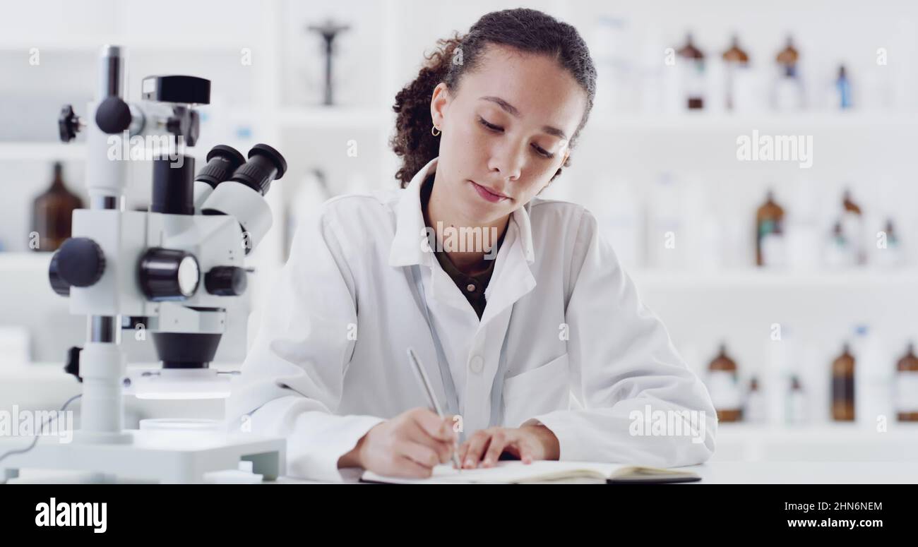 Dedicated to science. 4k video footage of a young scientist using a ...
