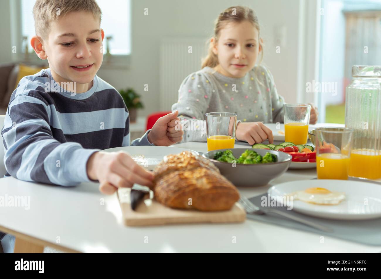 Teen children having healthy breakfast at home in the morning before ...