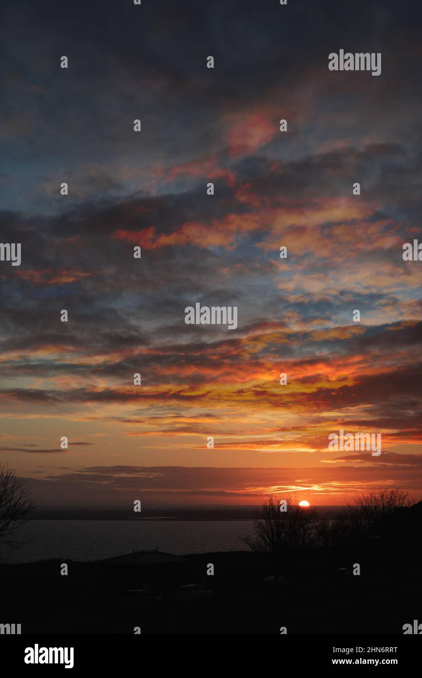 Beautiful sunset on a cloudy evening. The sun is just disappearing ...