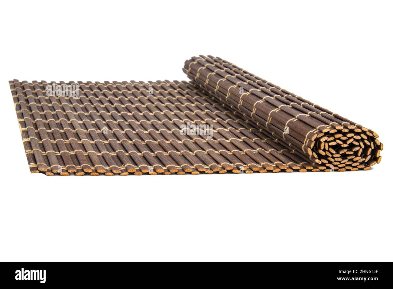 Rolled bamboo mat for food dark color isolated on the white background ...