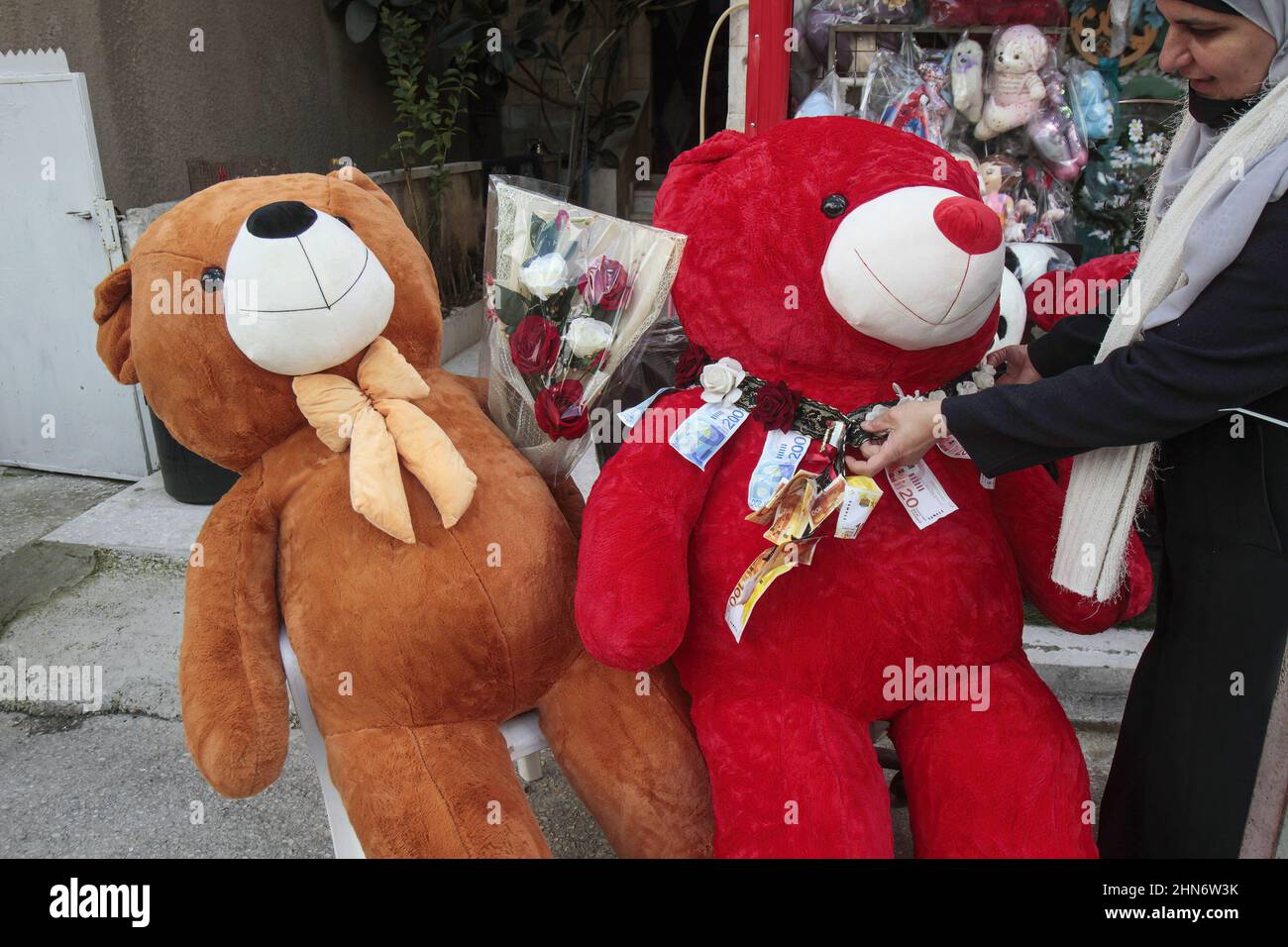 Nablus, Palestine. 14th Feb, 2022. A Palestinian displays teddy bears ...