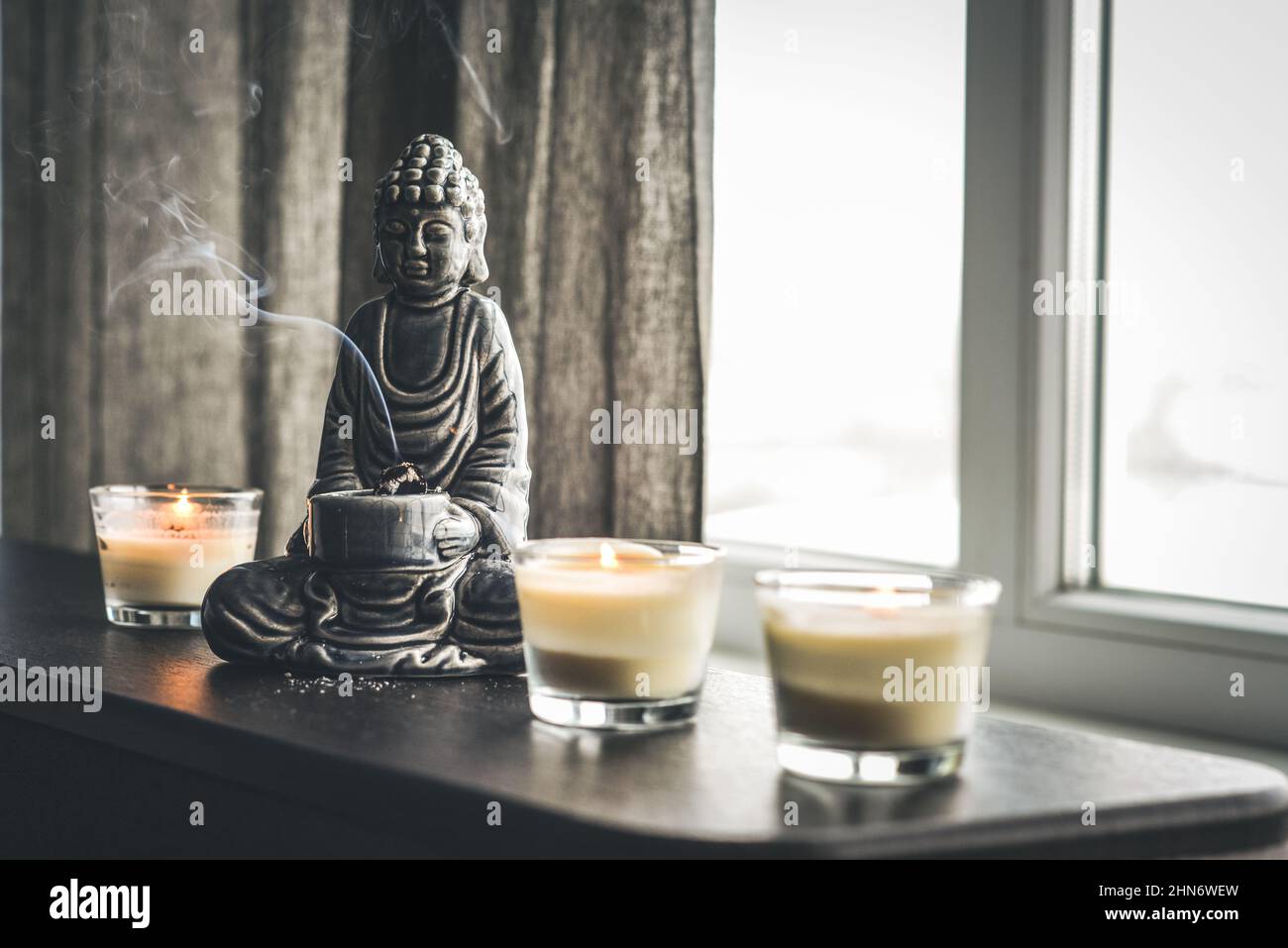 Candlestick in the shape of a buddha, smoldering Palo Santo and burning ...